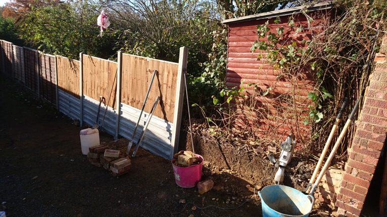Closeboard panel on concrete gravel board retaining wall in Stevenage ...