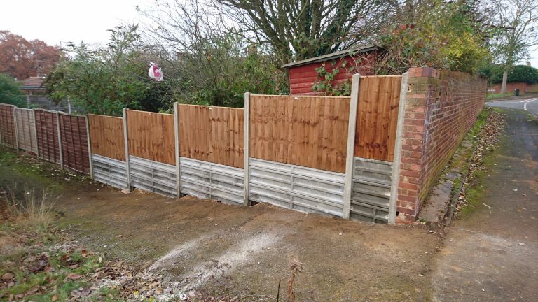 Closeboard panel on concrete gravel board retaining wall in Stevenage ...